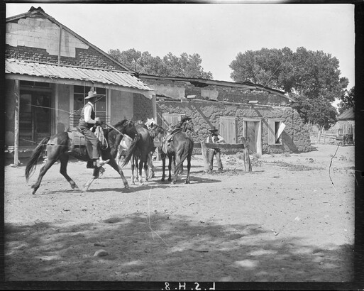 Cowpunchers from the LS and LIT ranches meeting at the horse racks ...