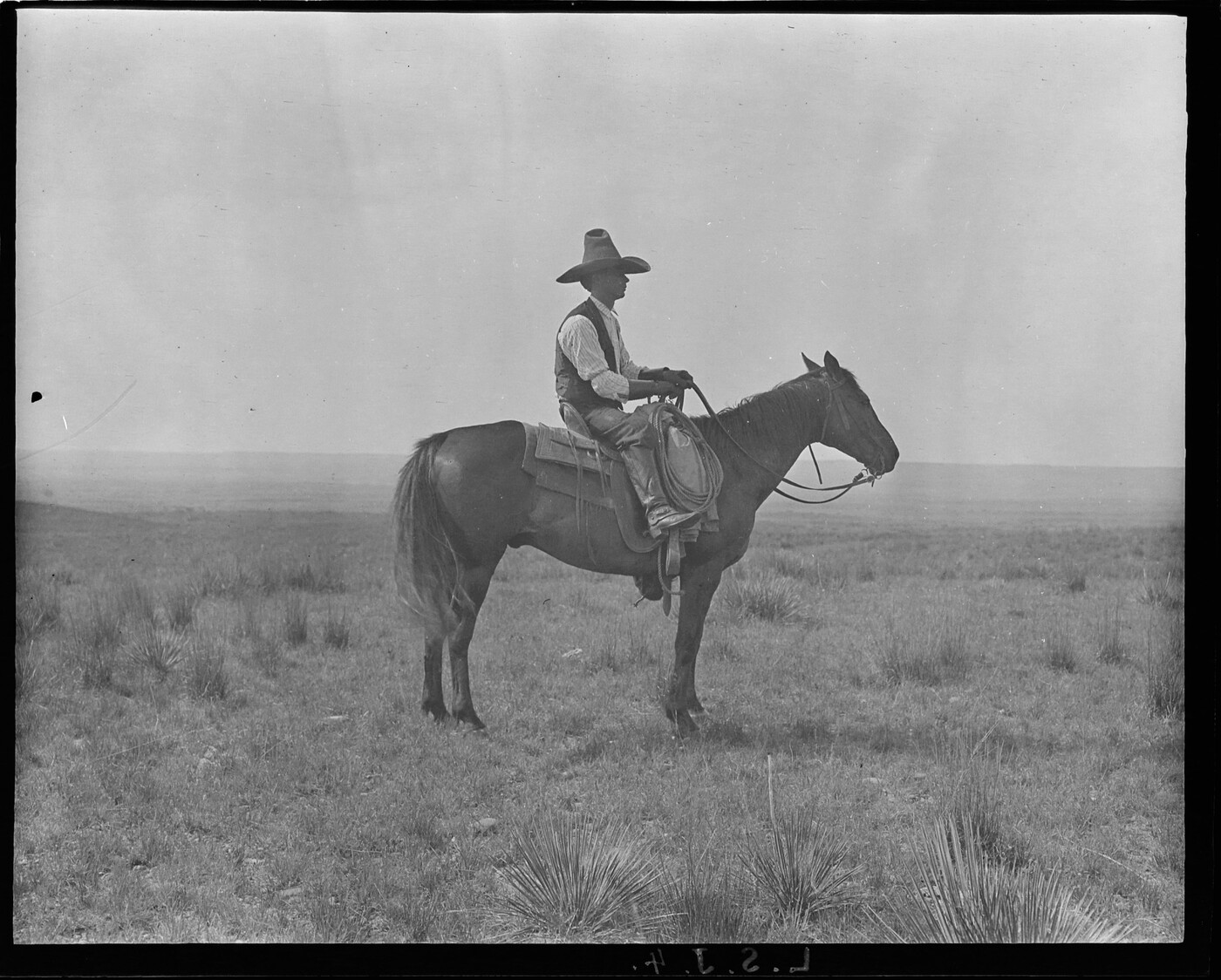 An LS cowhand sitting easy in the saddle. LS Ranch, near Tascosa, Texas ...
