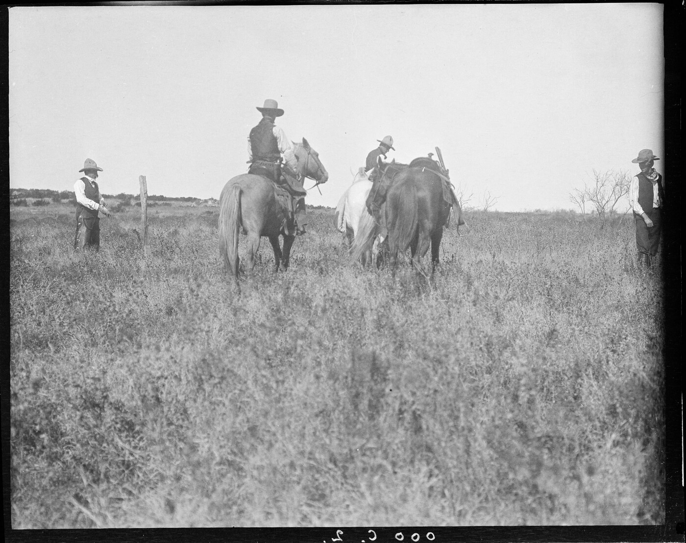 4 Cowboys - 2 standing. [Three Circle foreman standing far left, Edwin ...