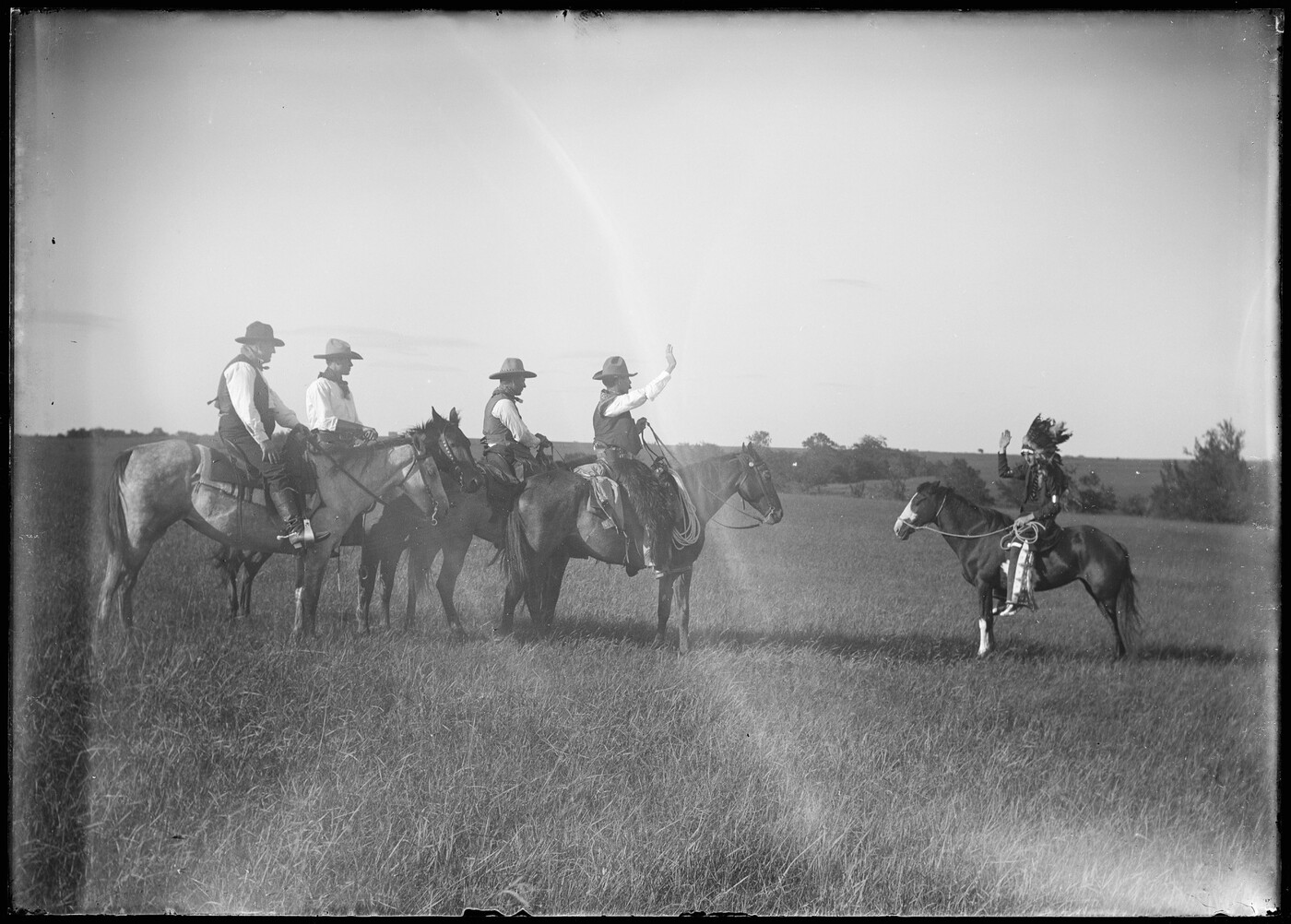 Men dressed for the part acting out, for fun, an Indian "pow-wow" for ...