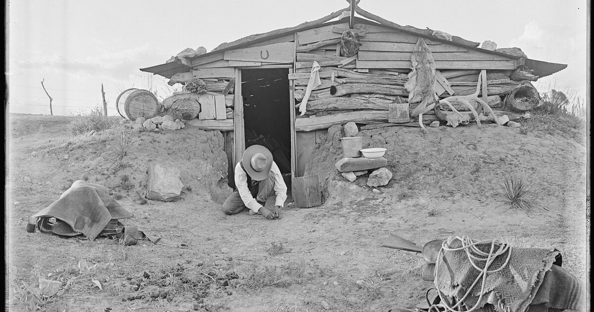Harry Campbell, Matador cowpuncher, in front of the line camp half ...