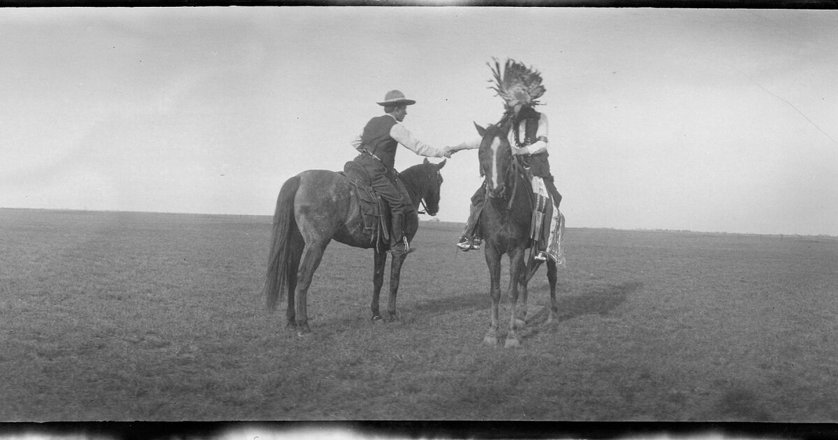 An Indian (Erwin E. Smith) shaking hands with one of the Matador ...