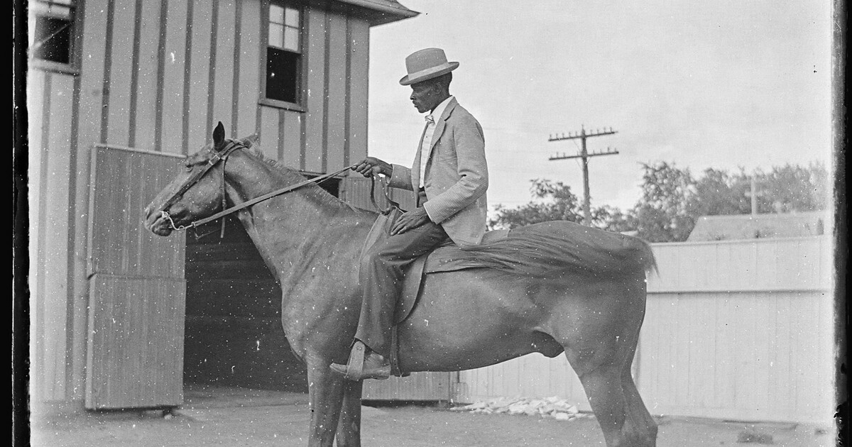 [Man mounted on horse before a carriage house, possibly in connection ...